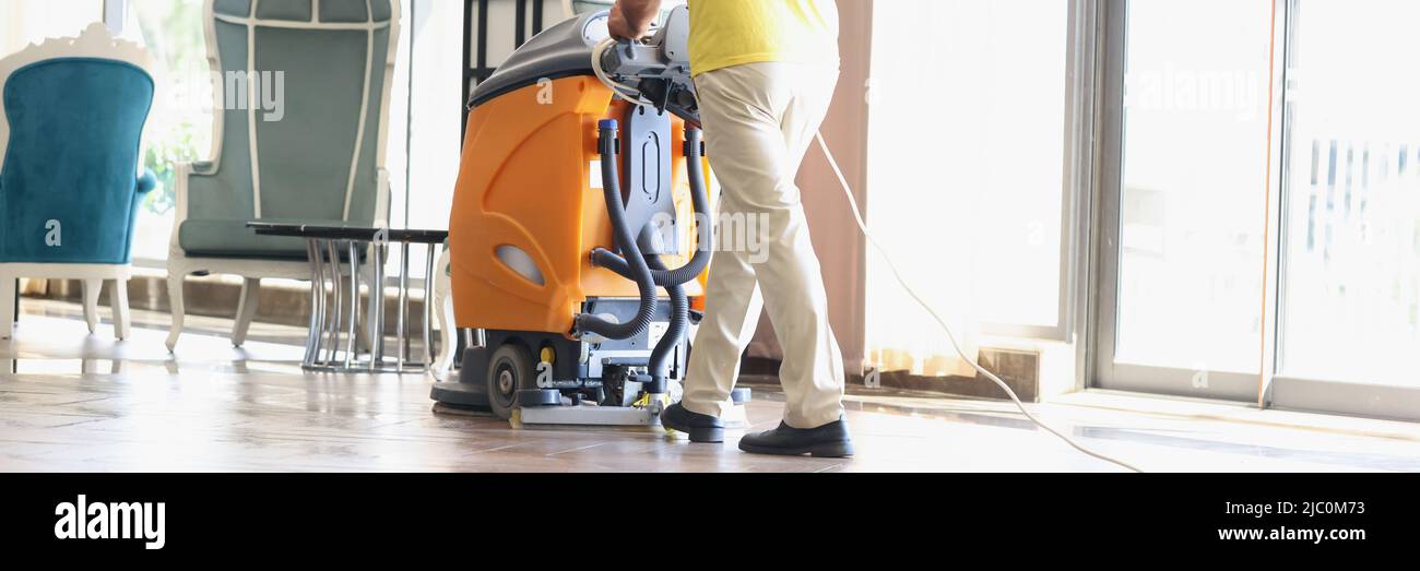 Male cleaner cleaning interior of modern hotel lobby Stock Photo - Alamy