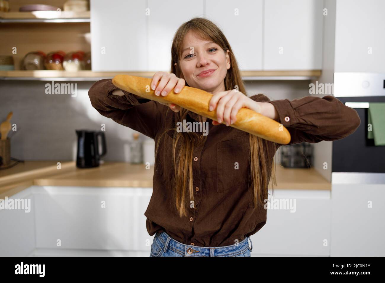 Woman holding loaf french bread hi-res stock photography and images - Alamy