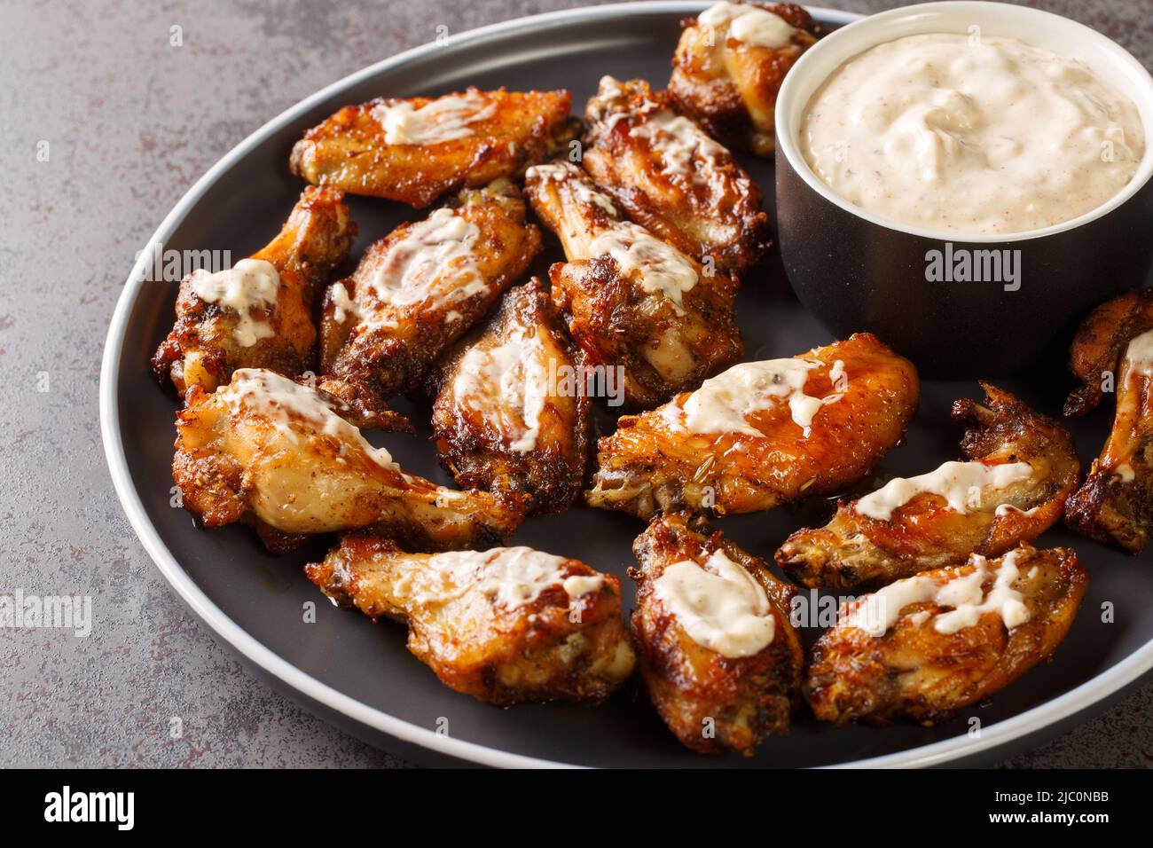 American Grilled Chicken Wings With Alabama White BBQ Sauce close-up in ...