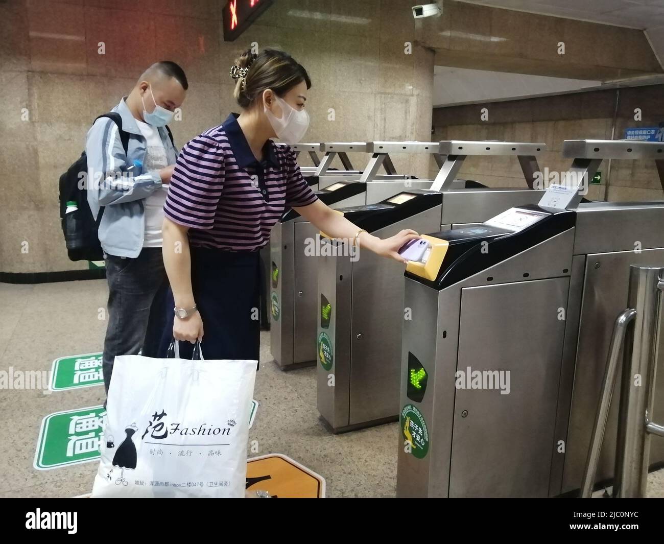 BEIJING, CHINA - JUNE 9, 2022 - A passenger scans a code to pass a ...