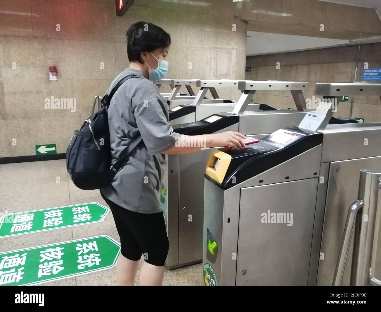 BEIJING, CHINA - JUNE 9, 2022 - A passenger scans a code to pass a ...