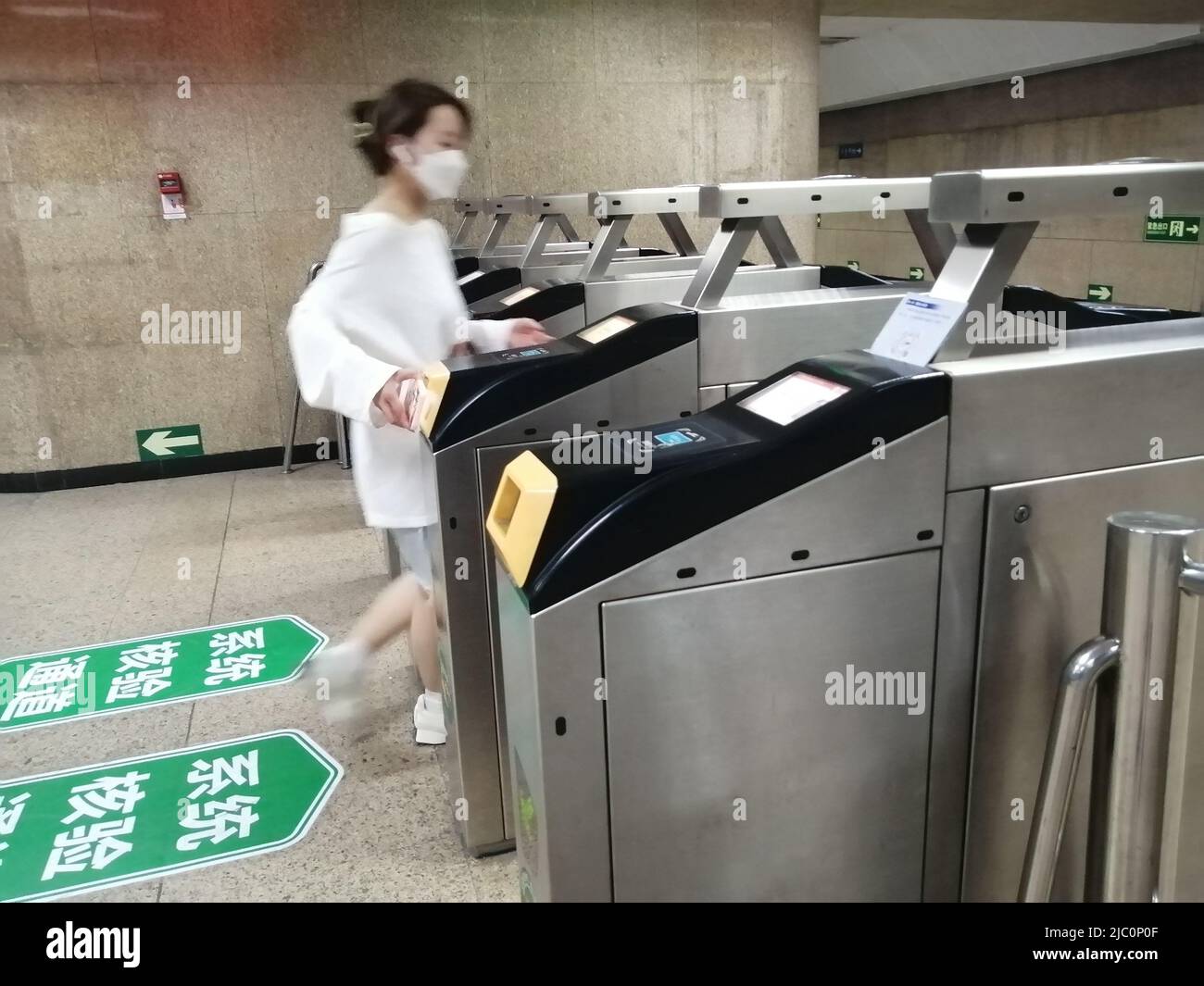 BEIJING, CHINA - JUNE 9, 2022 - A passenger scans a code to pass a ...
