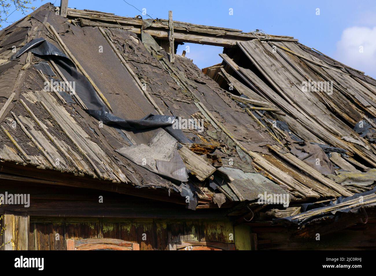 Old rural abandoned wooden collapsing house. Old roof, destroyed ...