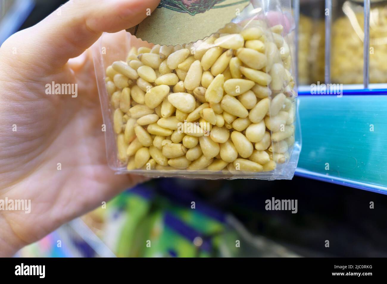 Pre packaged snacks pine nuts on the shelves of the hypermarket ...