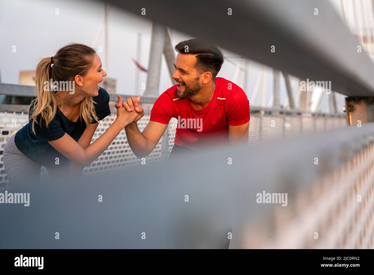 Romantic couple doing sport together on the street. Having fun after ...