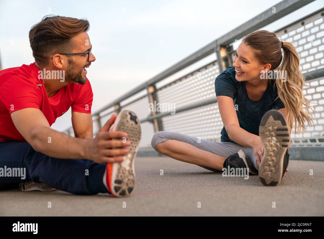 Romantic couple doing sport together on the street. Having fun after ...