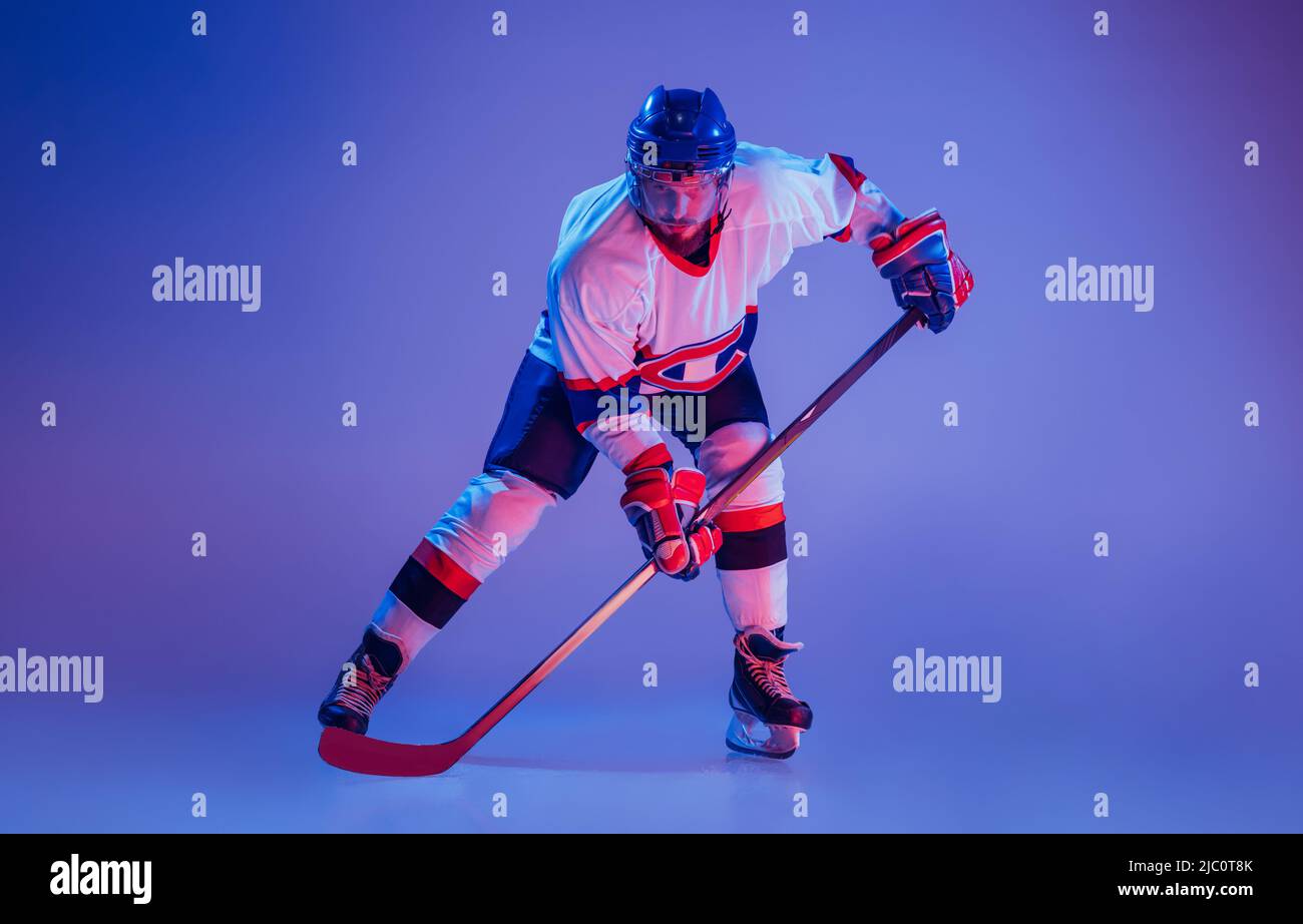In action. Professional hockey player in sports uniform and protective ...