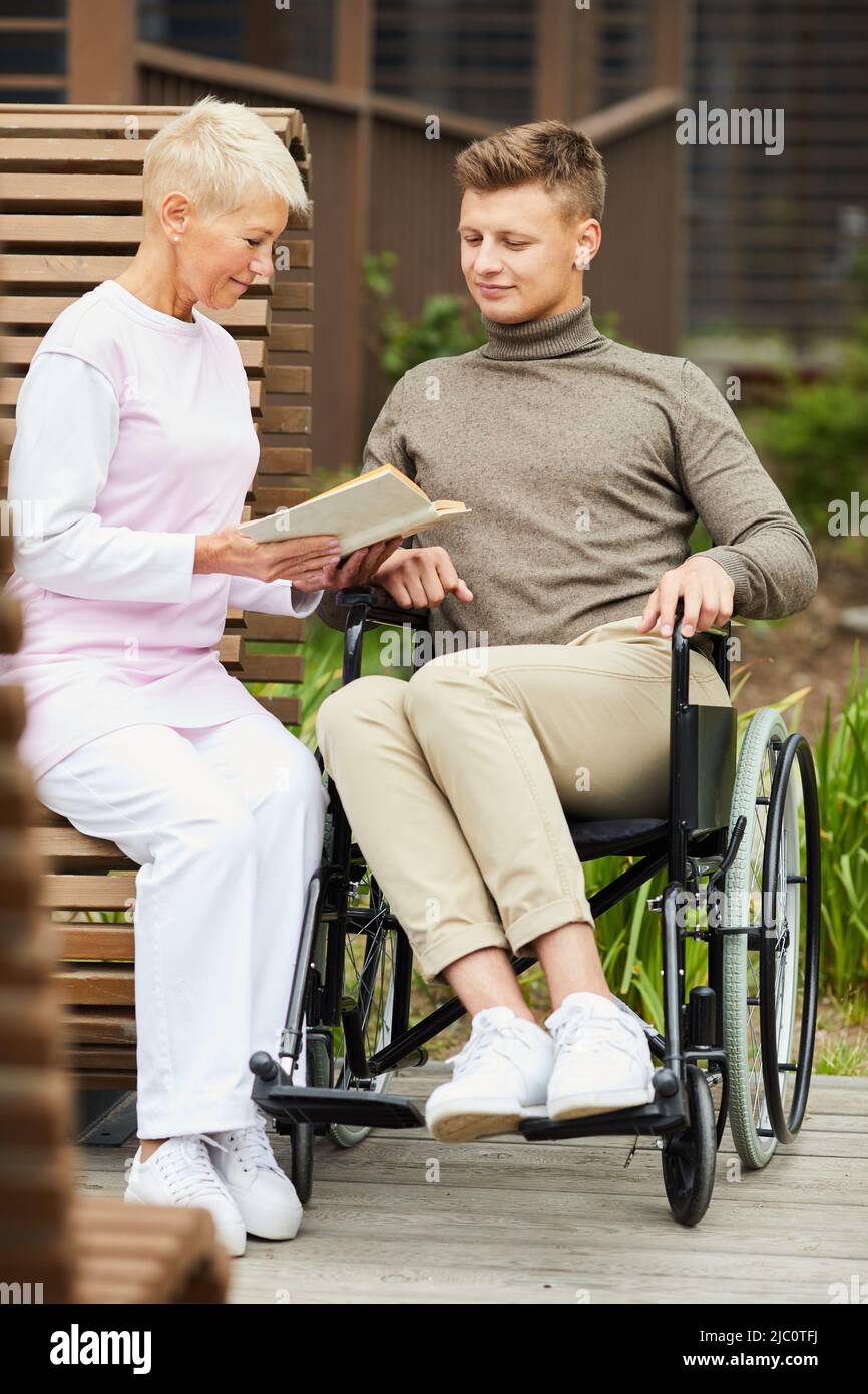 Content attractive healthcare worker in uniform sitting on bench in ...