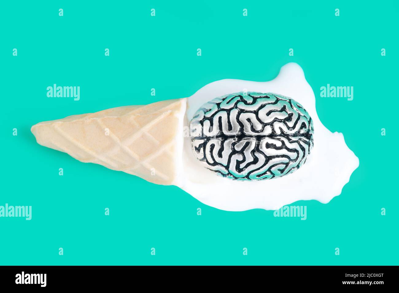 Anatomical steel copy of a human brain placed on a puddle of melted ...