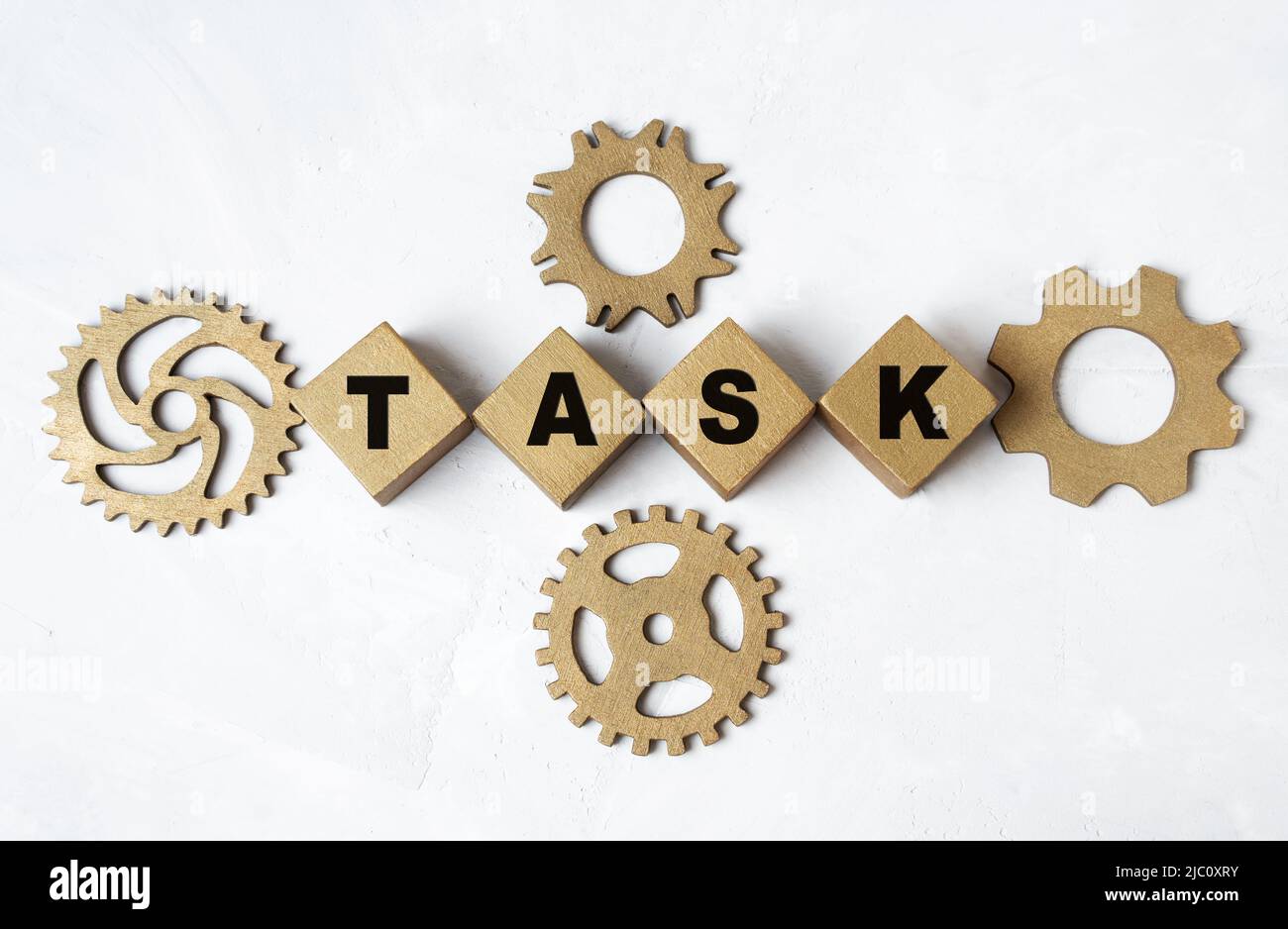 Word TASK made from letter blocks with cogs and gears arranged on a ...