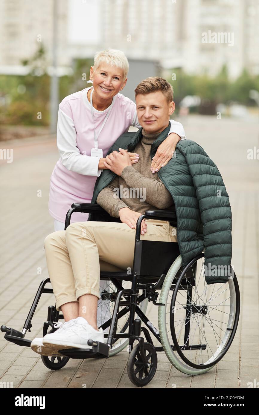 Portrait of cheerful careful female social care worker with badge ...