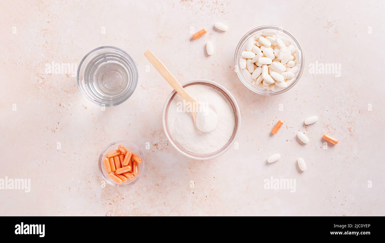 Collagen powder, glass of water and collagen pills on neutral beige ...
