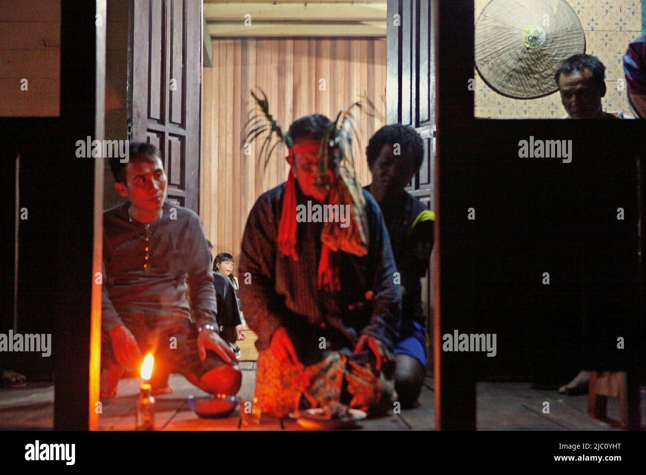 A witch doctor conducting a ritual on the porch of Dayak Iban's ...