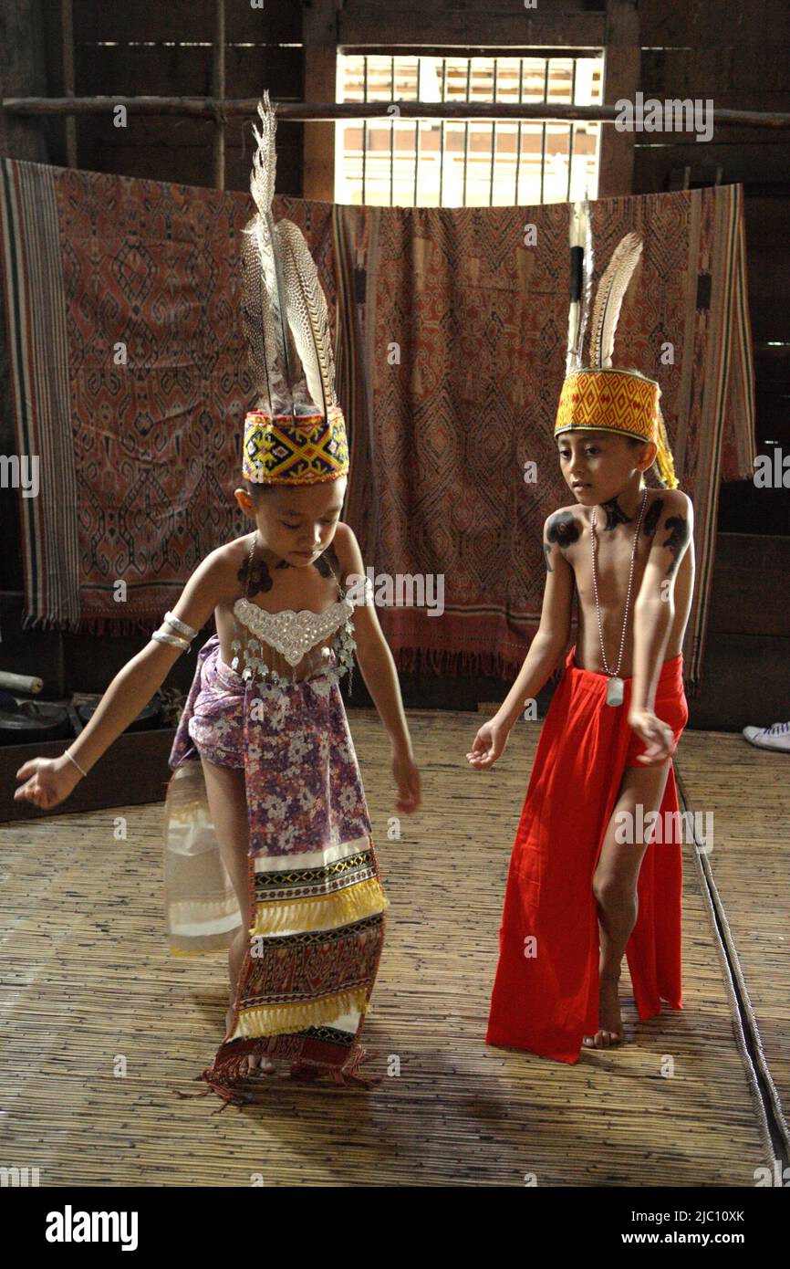 Children in traditional attires performing a traditional dance during ...