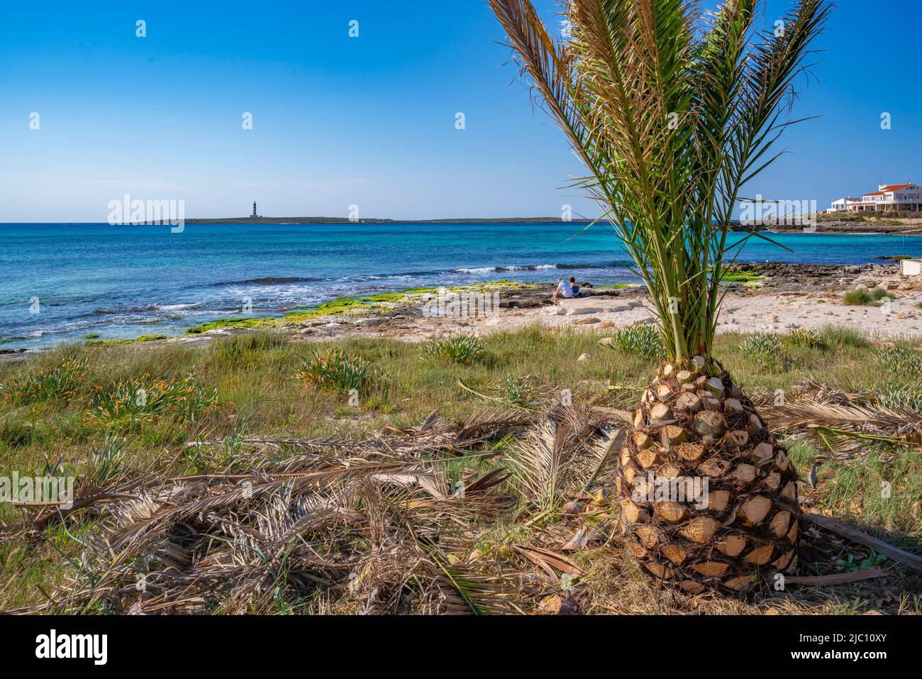 View of couple on Playa Punta Prima looking out to lighthouse, Punta ...