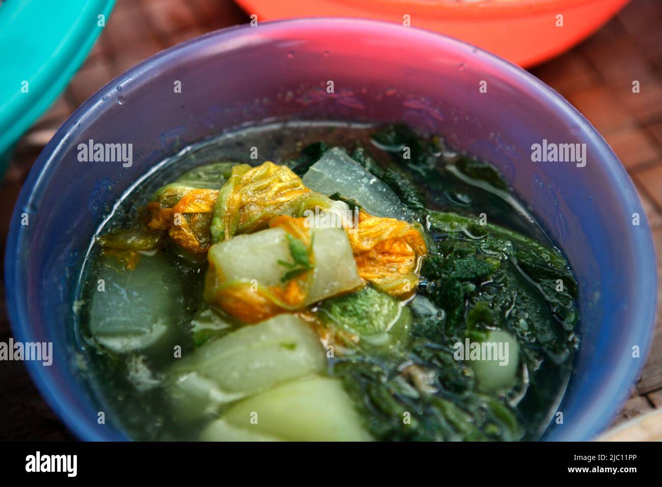 Vegetable soup is served for a communal lunch among traditional Dayak ...