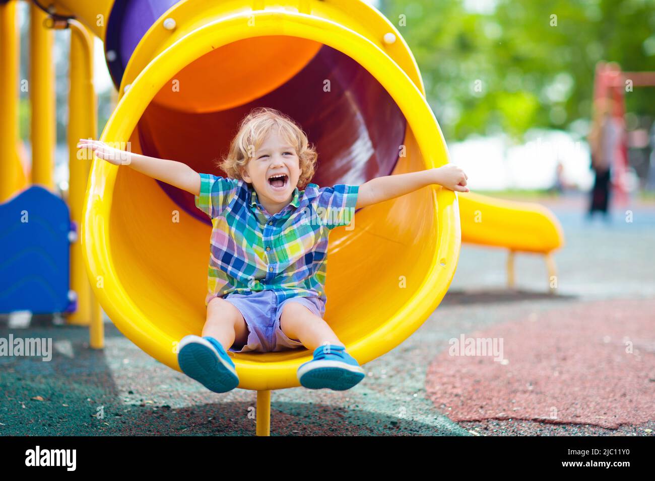 Child playing on outdoor playground. Kids play on school or ...