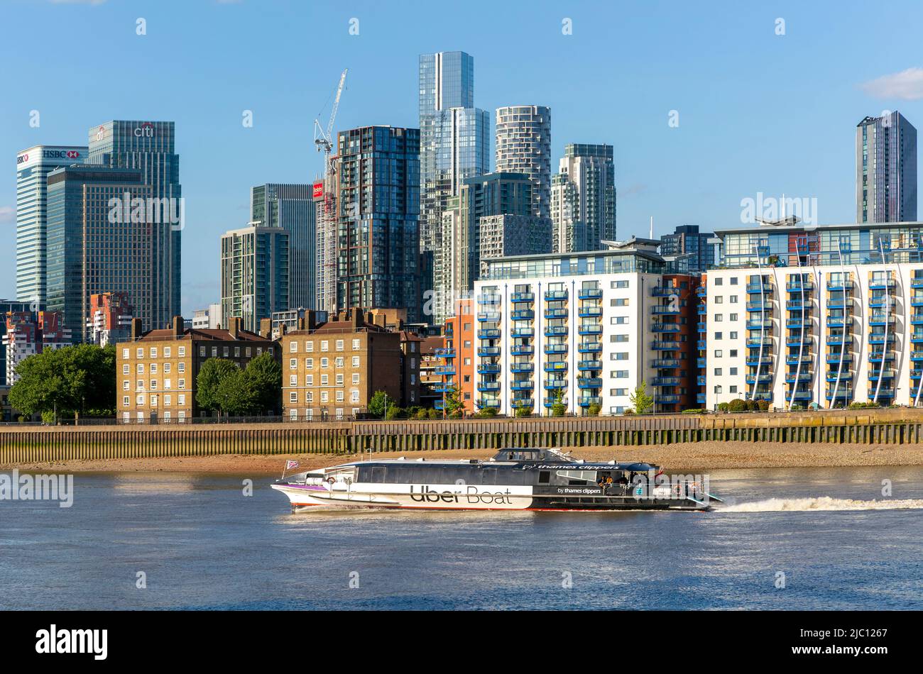 Uber boat water bus service passing Canary Wharf, Isle of Dogs, London ...