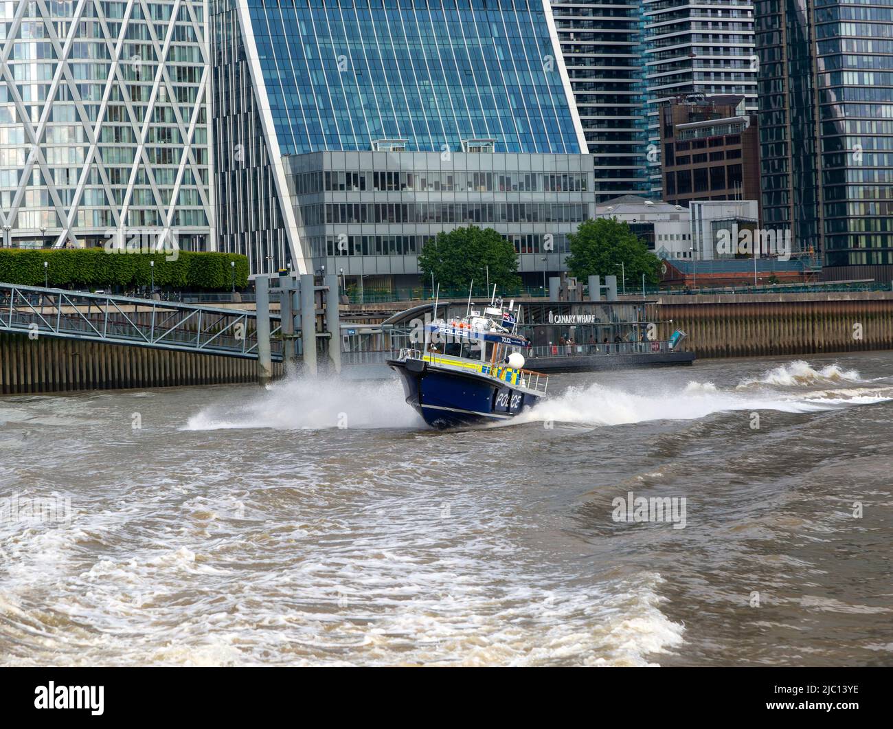 Metropolitan police speedboat motor launch travelling at high speed ...