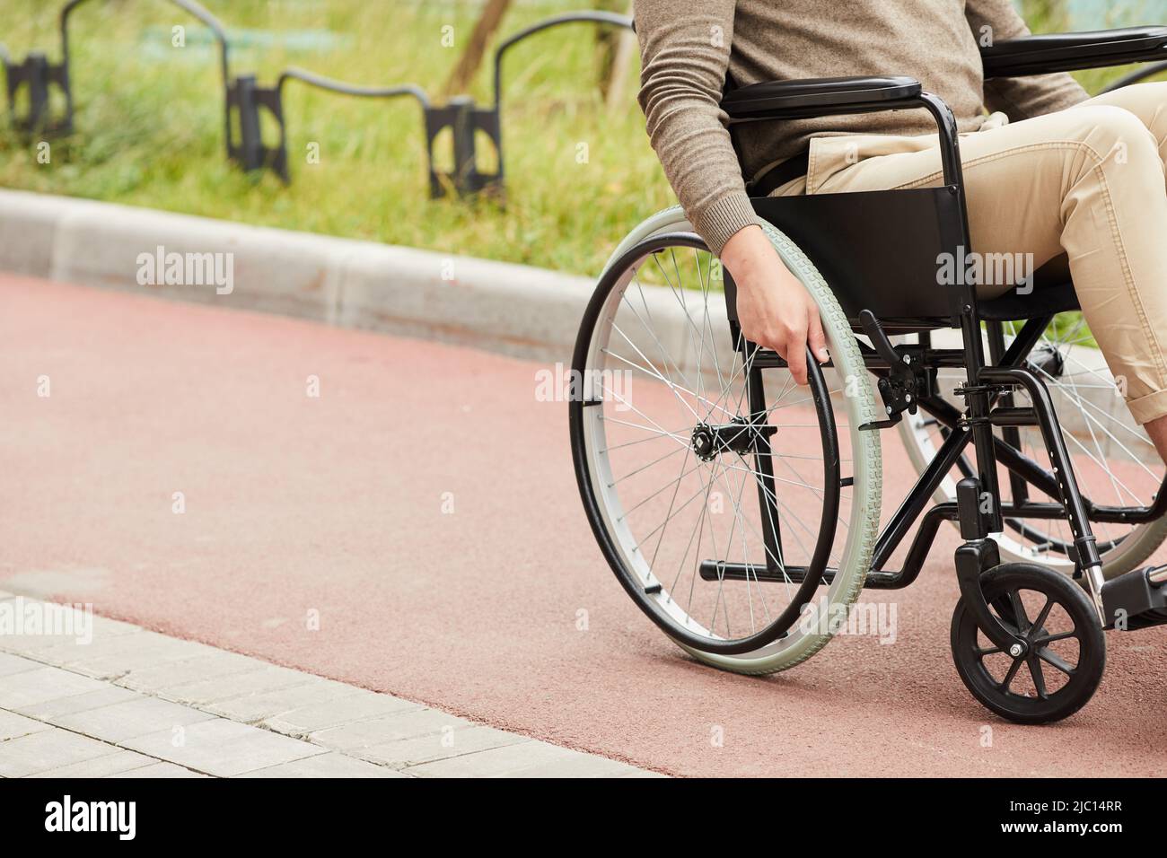 Close-up of unrecognizable guy in casual clothing sitting in modern ...