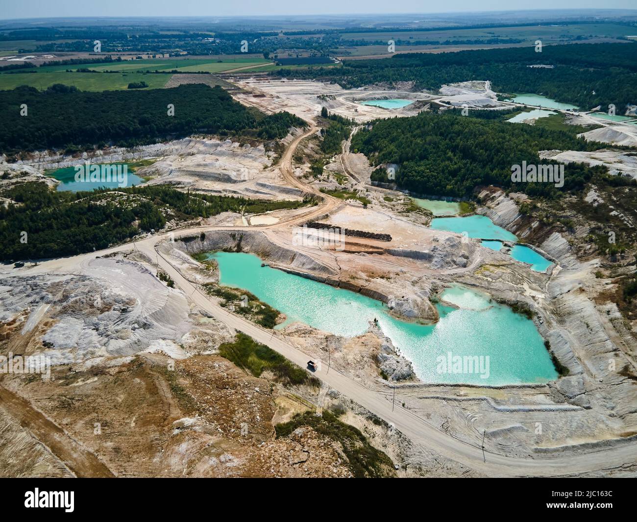 Aerial view quarry extraction porcelain clay, kaolin, with turquoise ...