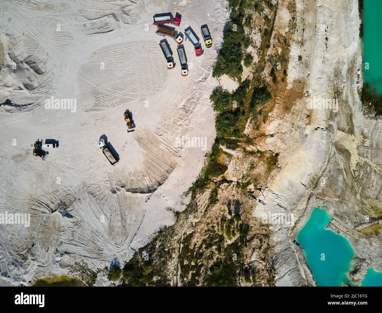 Aerial view trucks near quarry extraction porcelain clay, kaolin, with ...