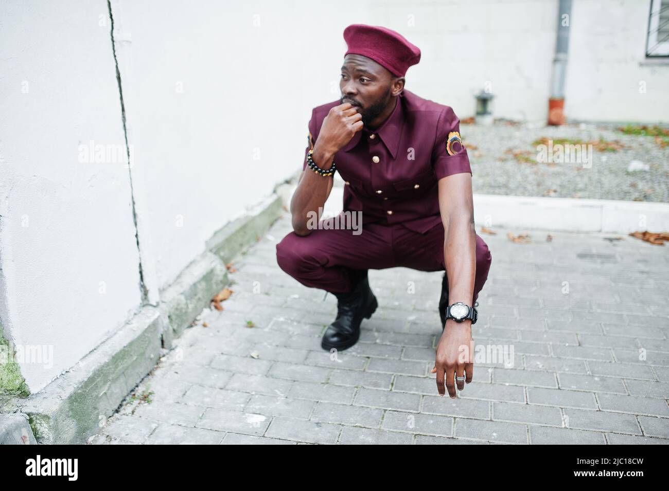 Portrait of African American military man in red uniform and beret ...