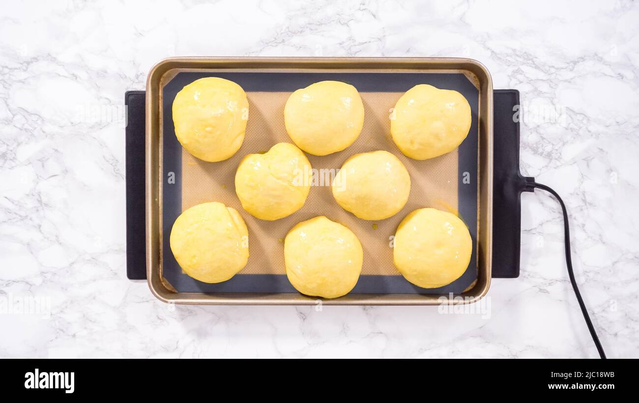 Flat lay. Step by step. Rising brioche dough on a baking sheet with a ...