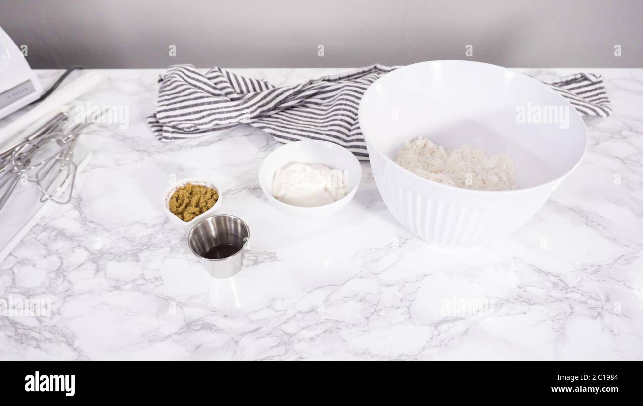 Step by step. Ingredients to bake cranberry muffins on a marble kitchen ...