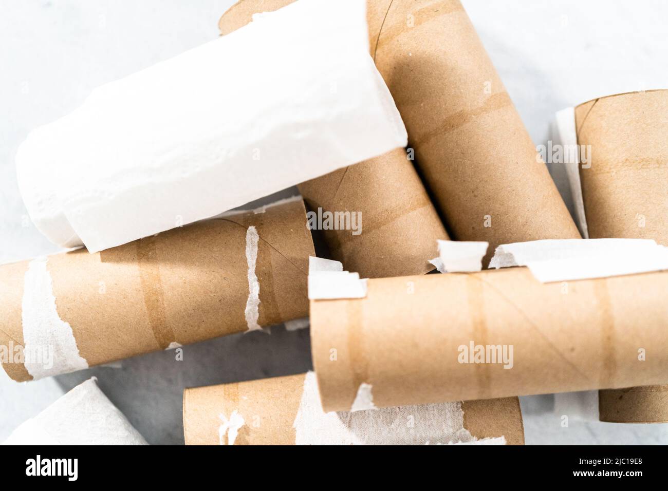 Used empty toilet paper rolls on a gray background Stock Photo - Alamy
