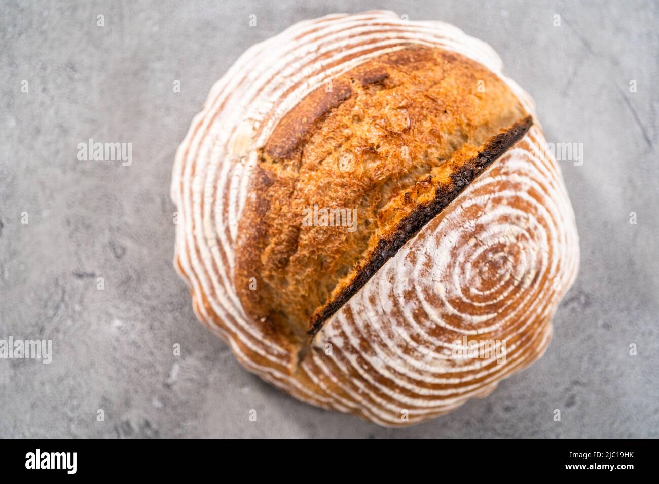 Freshly baked loaf of a wheat sourdough bread with marks from bread ...