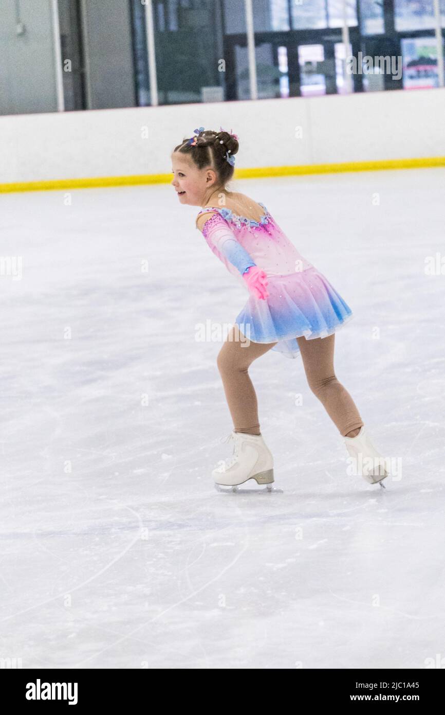Little girl practicing figure skating on an indoor ice rink Stock Photo ...