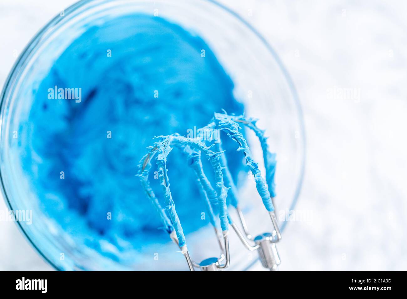 Mixing in food coloring into the store-bought vanilla buttercream ...