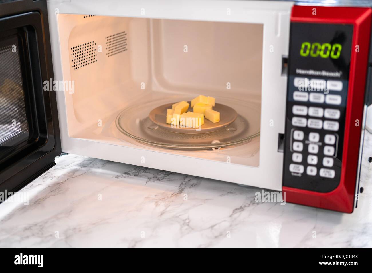 Softened sticks of unsalted butter on in the microwave Stock Photo - Alamy