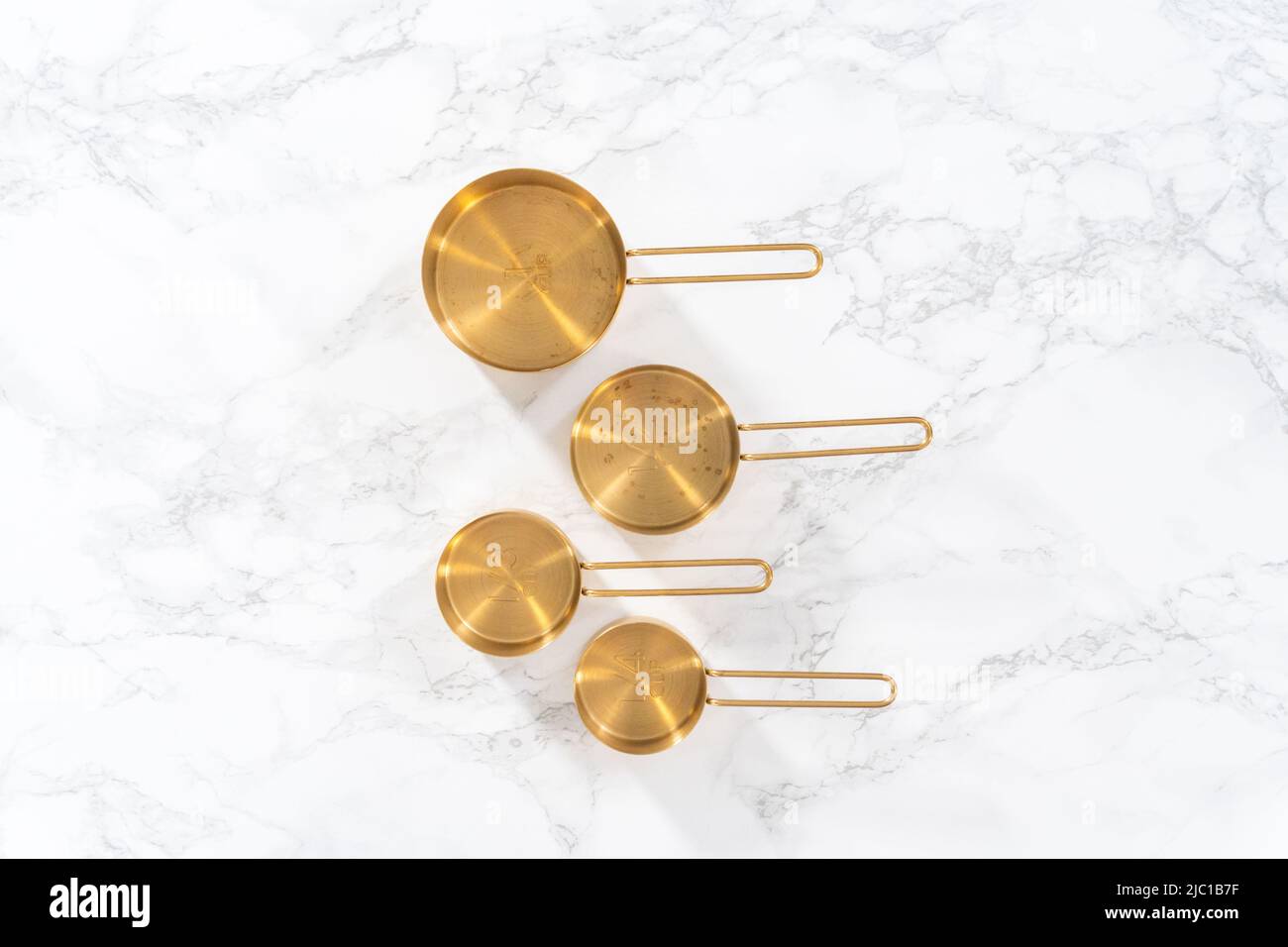 Flat lay. Cupper measuring cups and spoons for baking on a marble ...