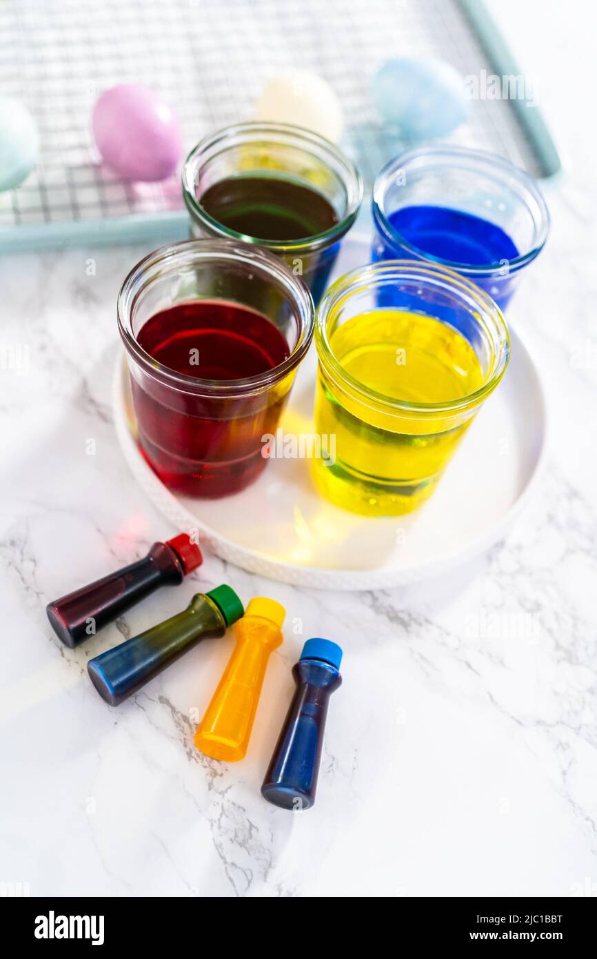 Coloring hard-boiled white eggs with natural food coloring Stock Photo ...