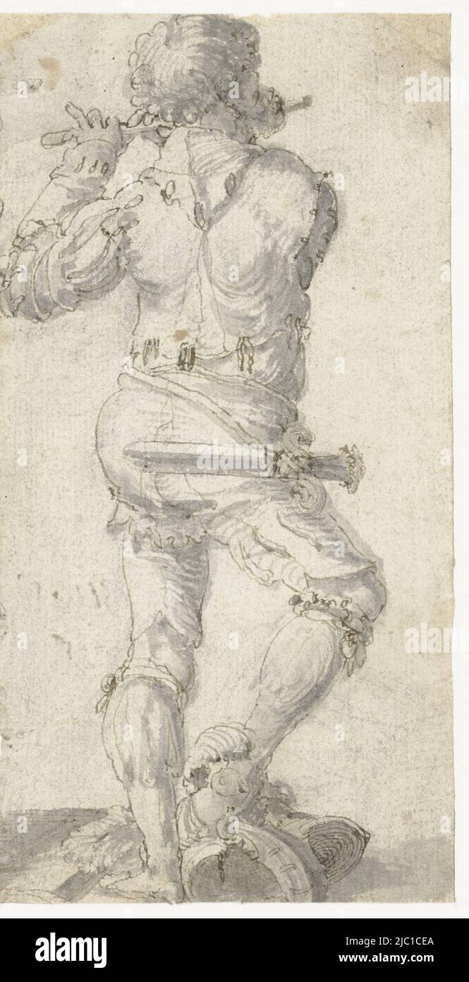 Flute player with his right foot on a helmet, seen from the back ...