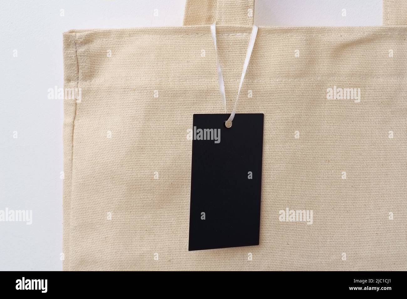 Eco bag for shopping with blank tag on white background Stock Photo - Alamy