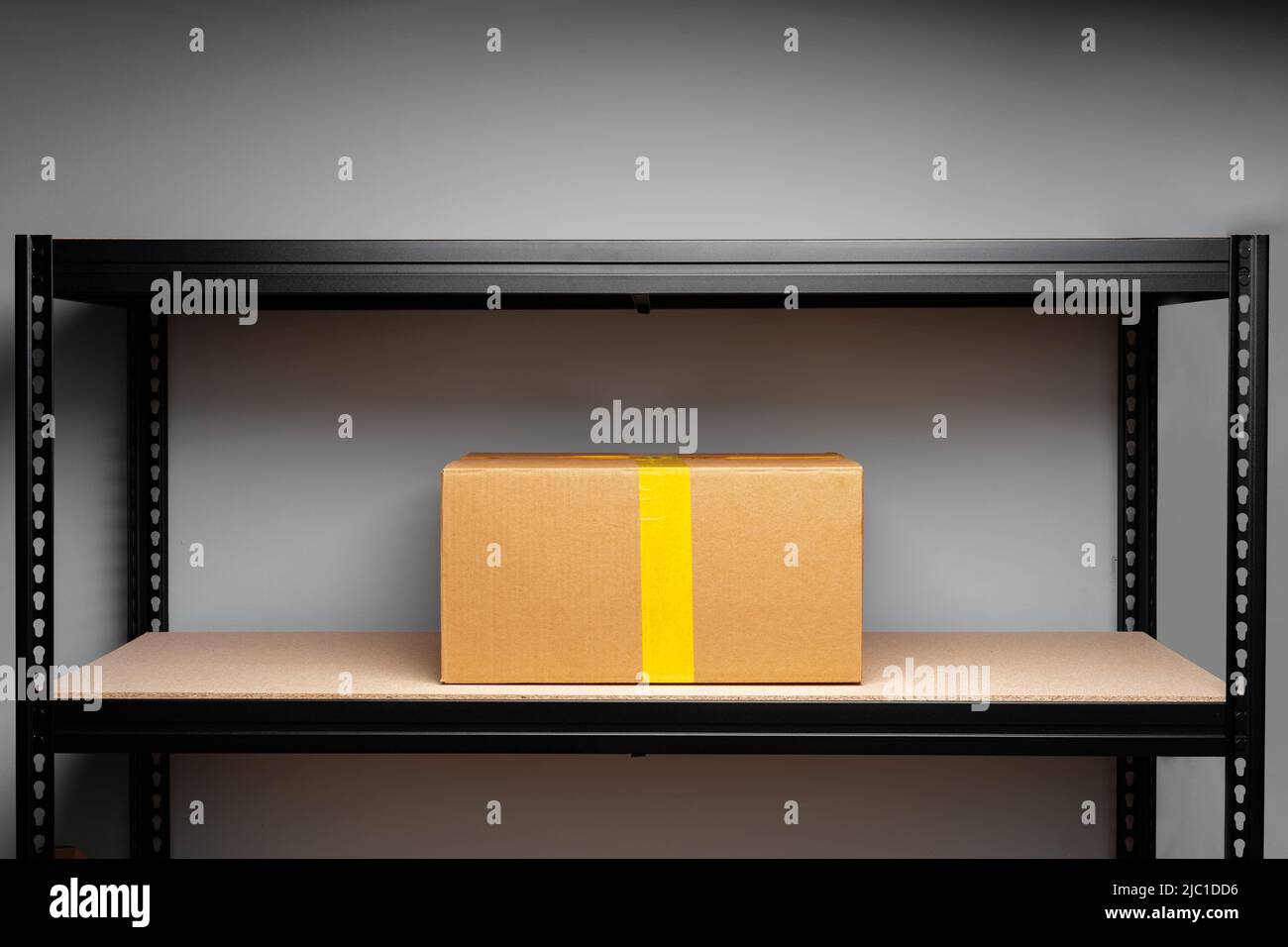 Stand shelf with one packed cardboard box Stock Photo - Alamy