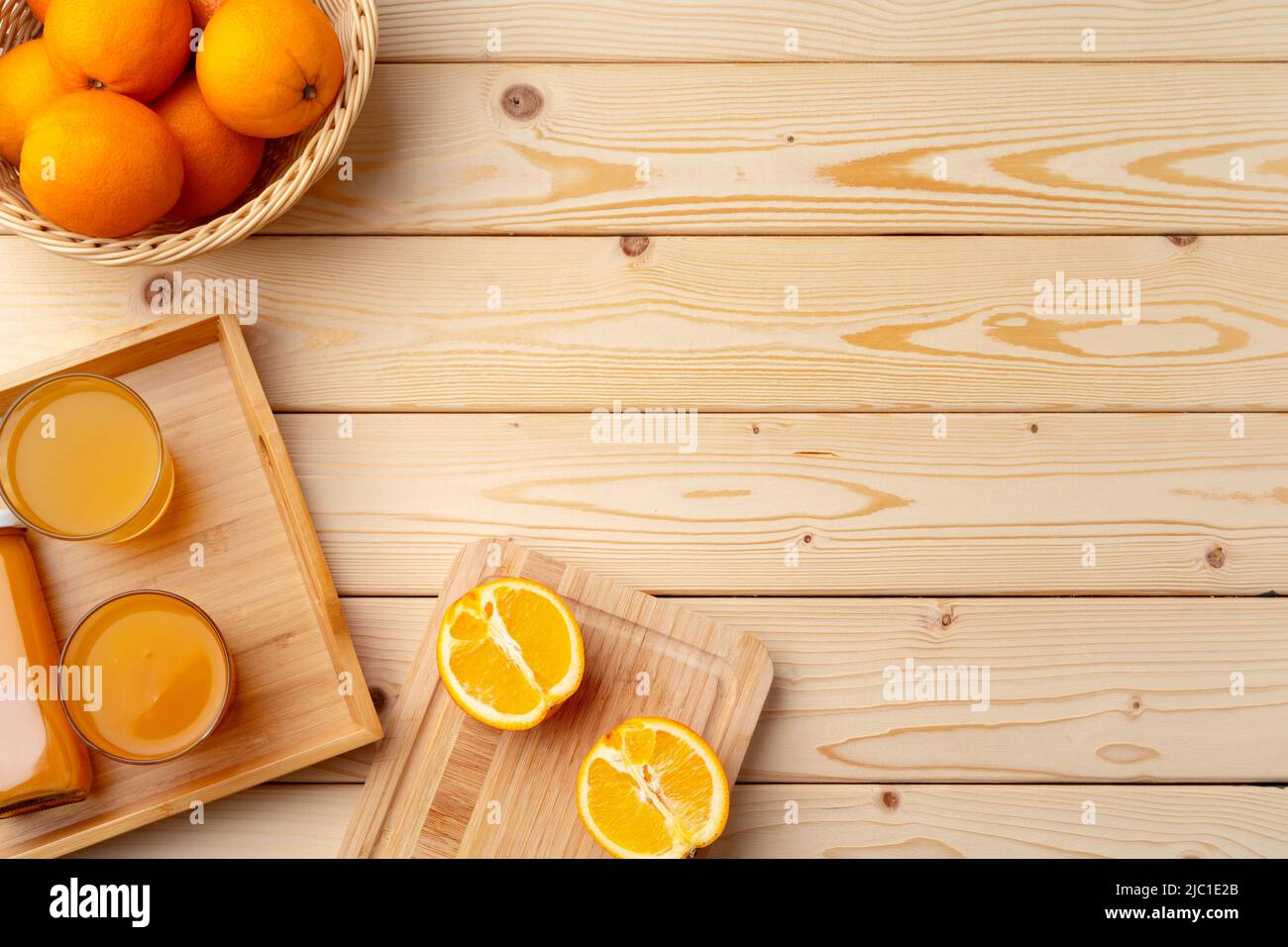 Fresh orange juice in the glass with orange fruit on wooden background ...