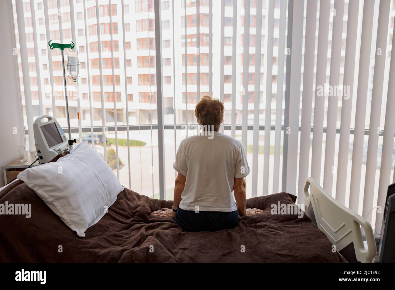 Patient sitting in hospital ward in clinic during the course of ...