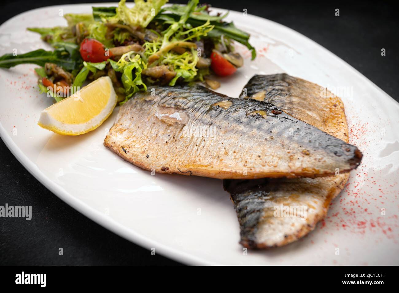 Two baked mackerel fillets on a plate Stock Photo - Alamy