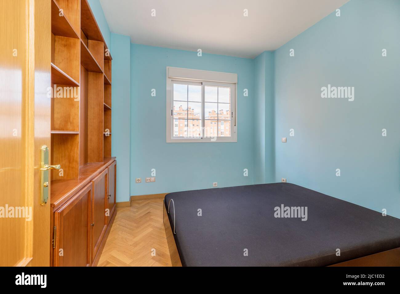 bedroom with double bed, wooden furniture with shelves and white ...