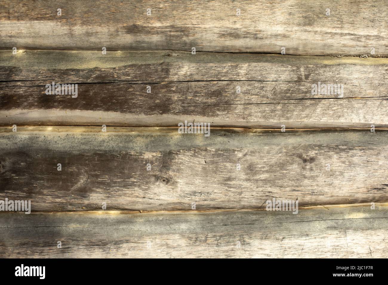 Texture of logs in wall. Details of house in village. Old surface is ...