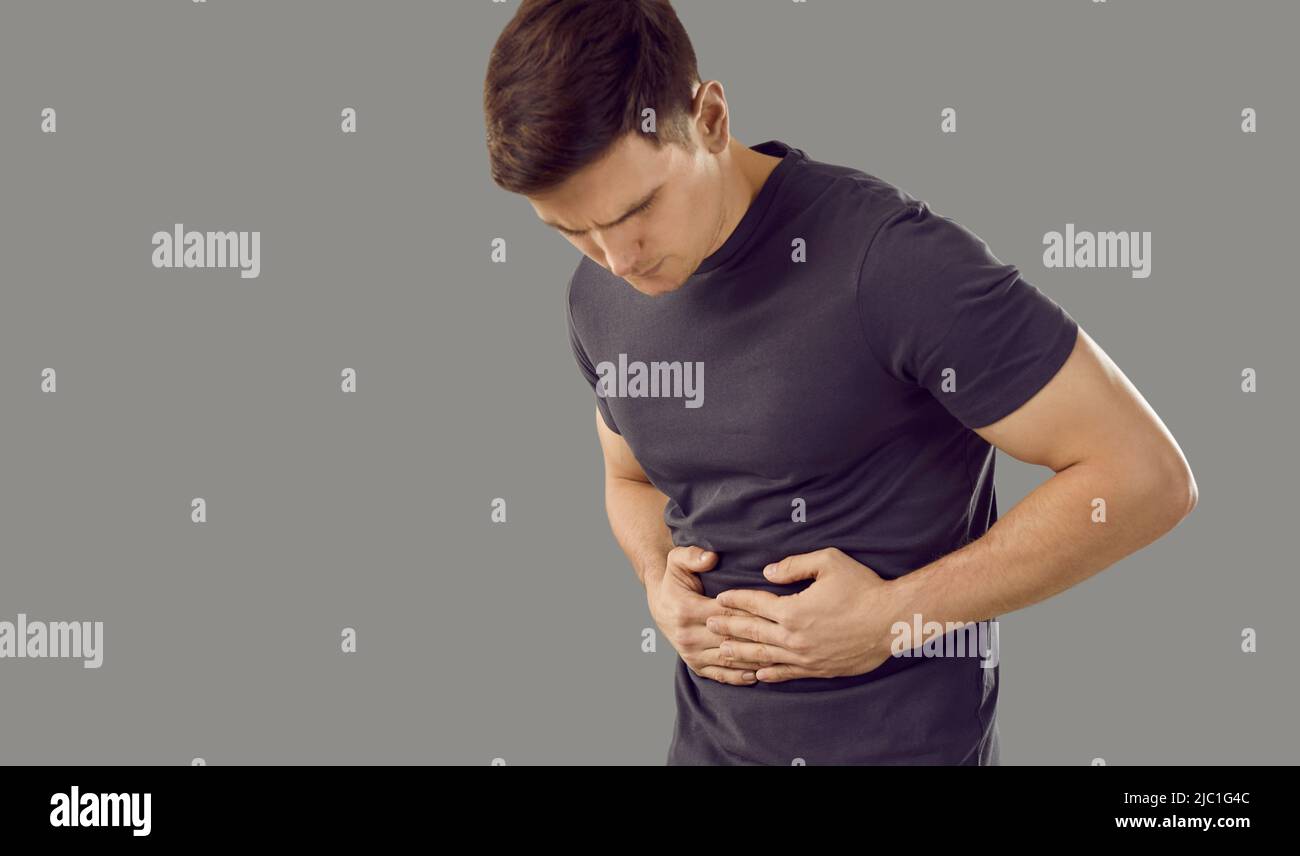 Unwell man having spasm or pain in abdomen Stock Photo - Alamy
