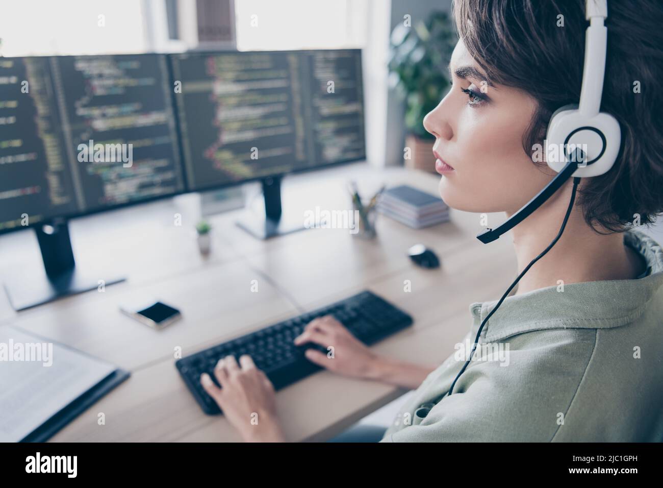 Photo of serious skilled operator keyboard writing look screens ...