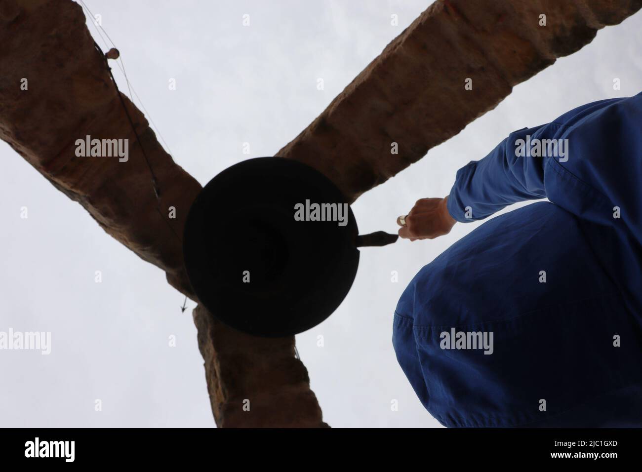 A woman ringing the church bell Stock Photo - Alamy
