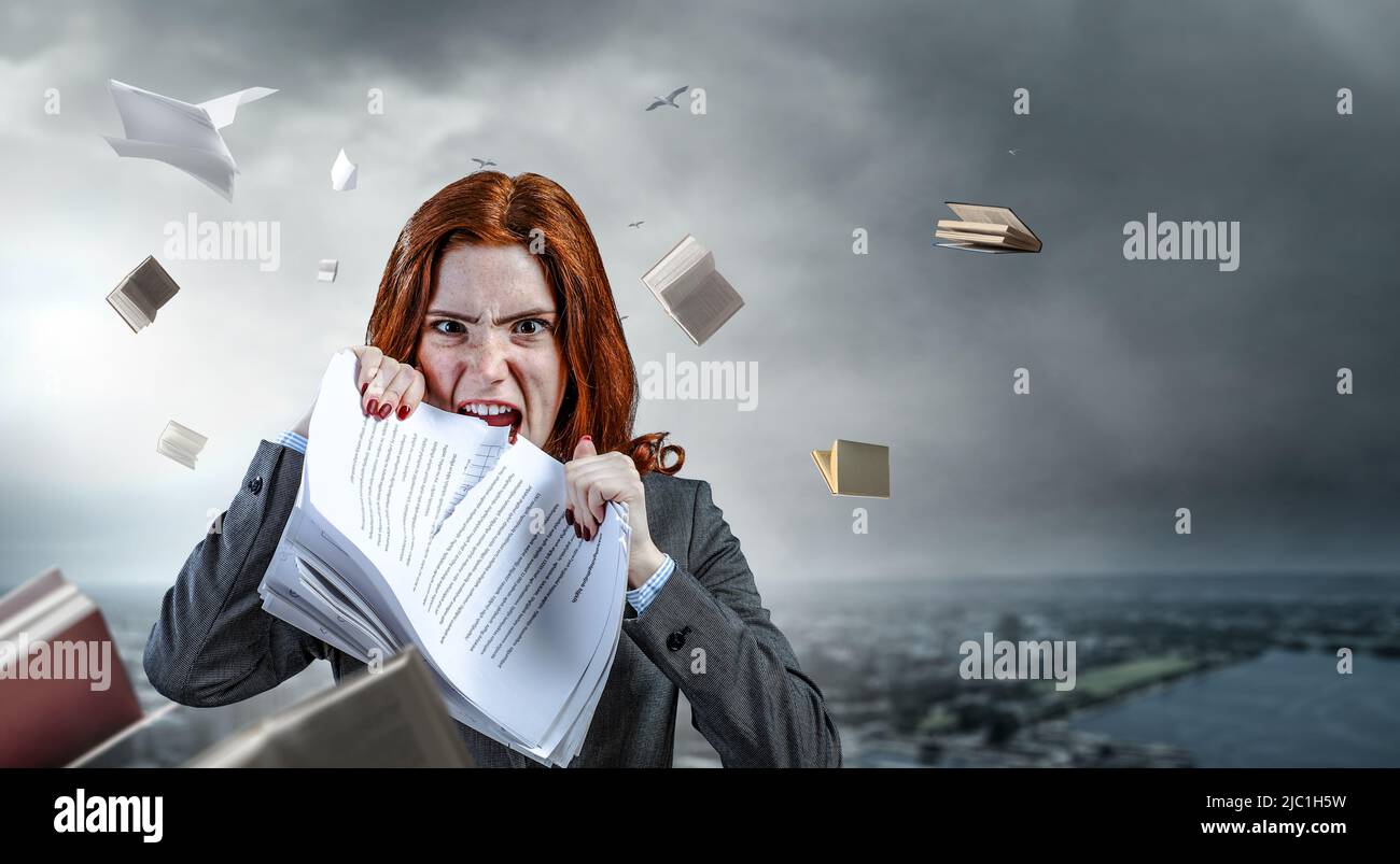 Young stressed woman ripping documents with frustrated facial ...