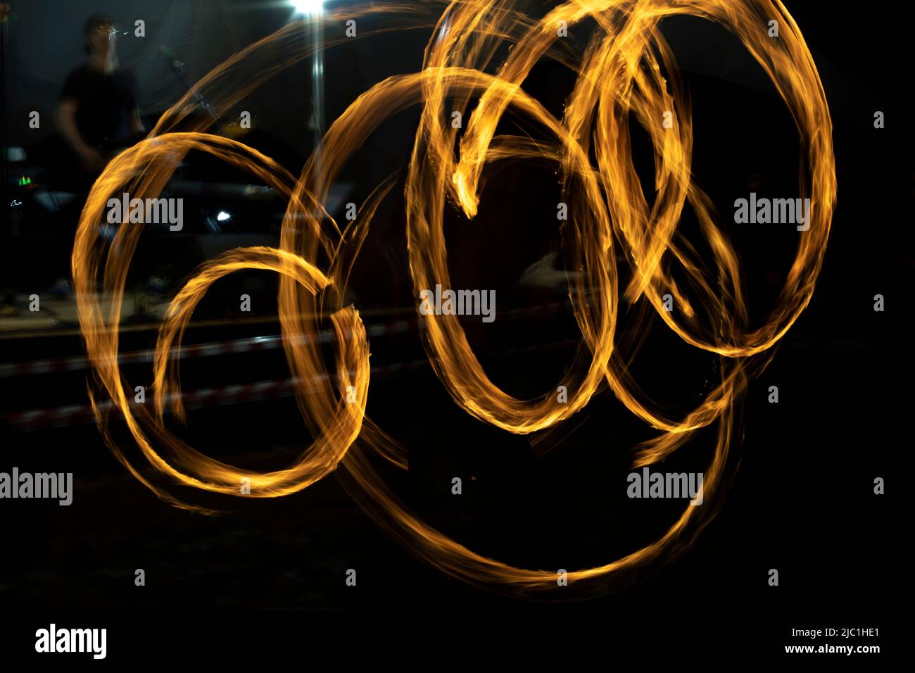 Circles of fire. Lines of flame. Shooting fire show on long shutter ...