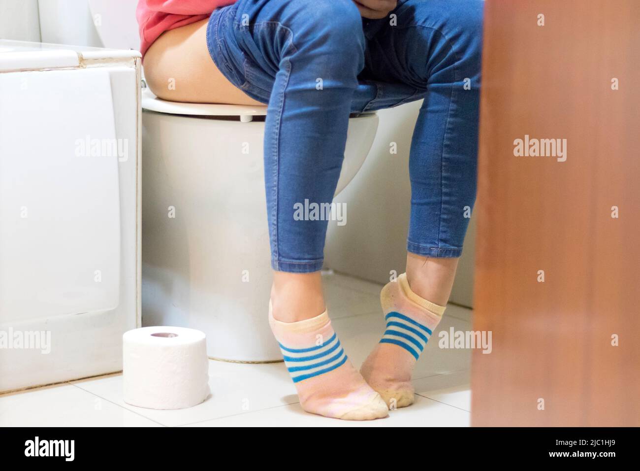close up photo woman with constipation or diarrhea sitting on toilet ...